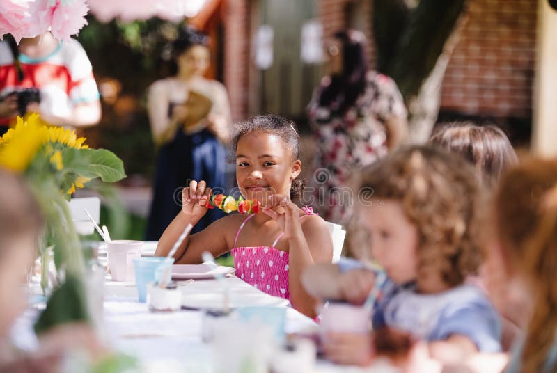 Small Children Sitting at the Table Outdoors on Garden Party, Eating ...
