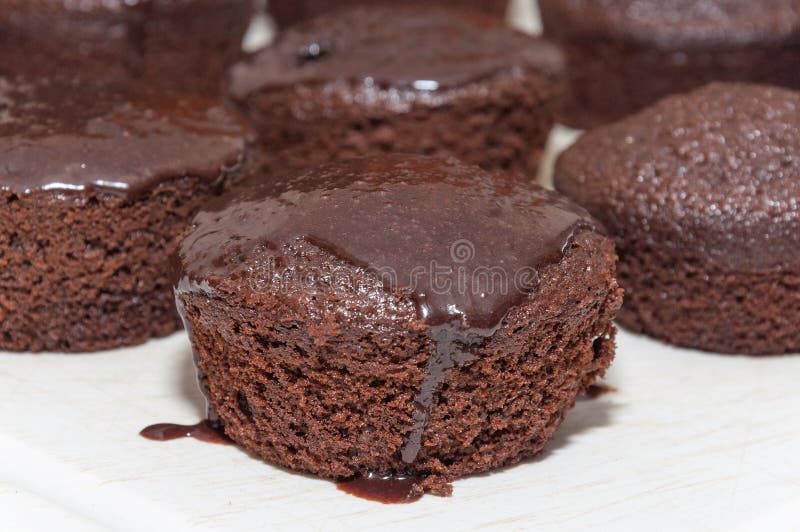 Small Chocolate Cakes with Dripping Chocolate Icing on Top Stock Image ...