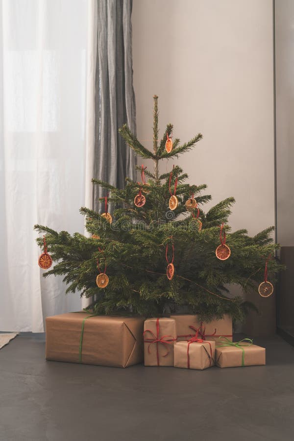 Small Christmas Tree with Natural Decorations and Gift Boxes Stock ...