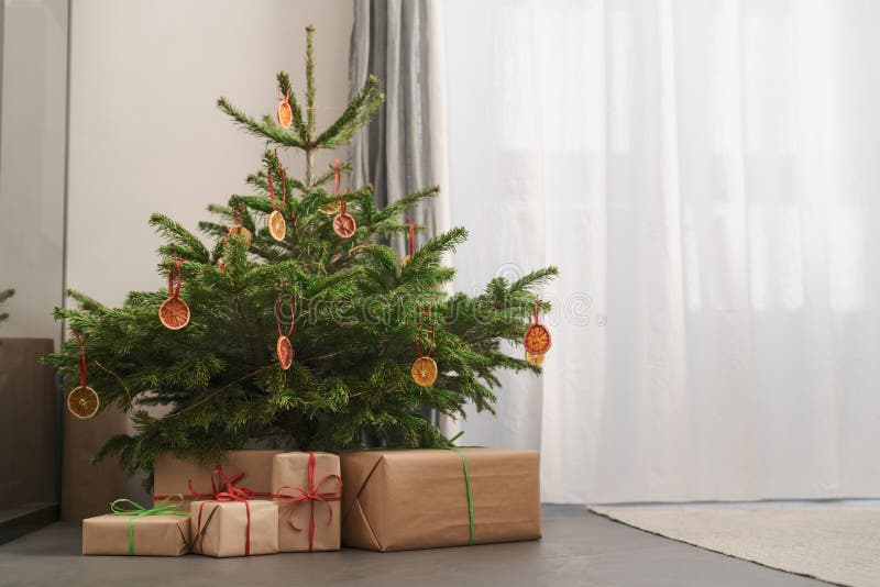Small Christmas Tree with Natural Decorations and Gift Boxes Stock ...