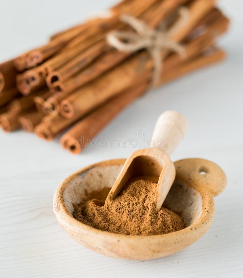 A Small Clay Pottery Bowl of Cinnamon Powder with Cinnamon Sticks in ...