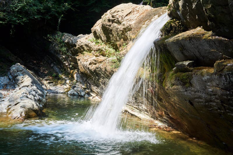 Small Clean Waterfall Falls from a Rocky Ledge in a Mountain Valley ...