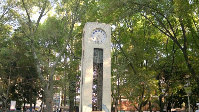 Small Clock Tower with Trees and Bright Sunlight As Background Stock ...