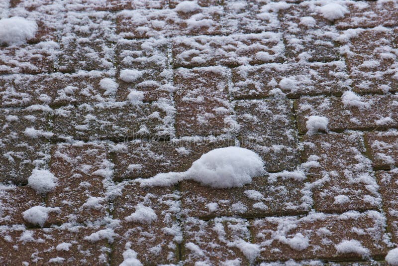 Small Clumps of Snow and Ice Covering a Brick Patio Stock Photo - Image ...