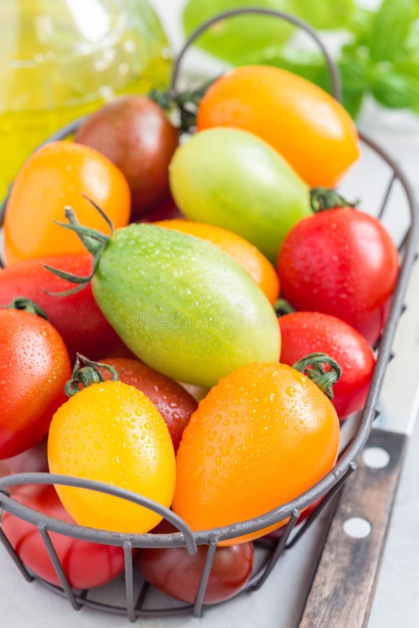 Small Colorful Cherry Tomatoes in Metal Basket, Vertical Stock Photo ...