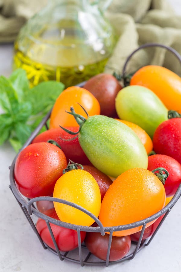 Small Colorful Cherry Tomatoes in Metal Basket, Vertical Stock Photo ...