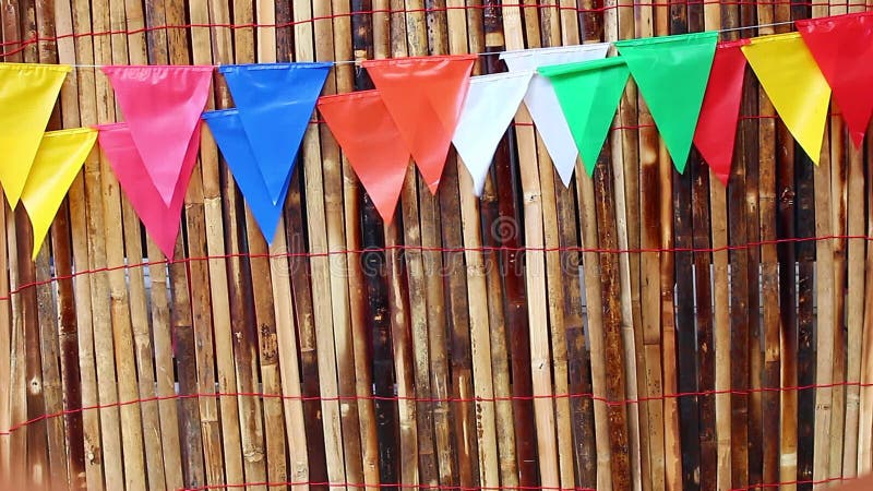 The Small Colorful Flags Chain Swinging in Wind Stock Footage - Video ...