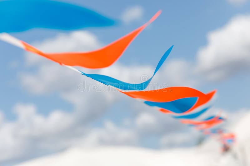 Small Colorful Orange and Blue Triangular Flags Against the Sky ...