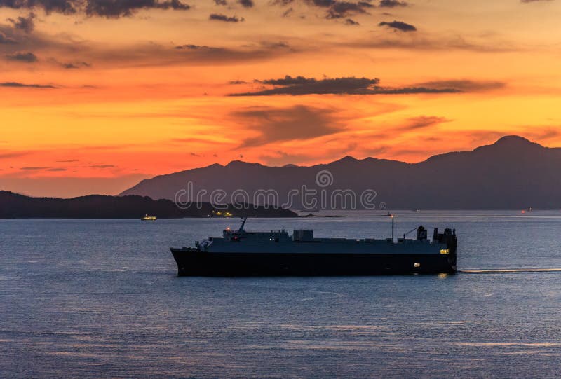 Small Container Ship Sails Blue Sea with Mountains in Background at ...