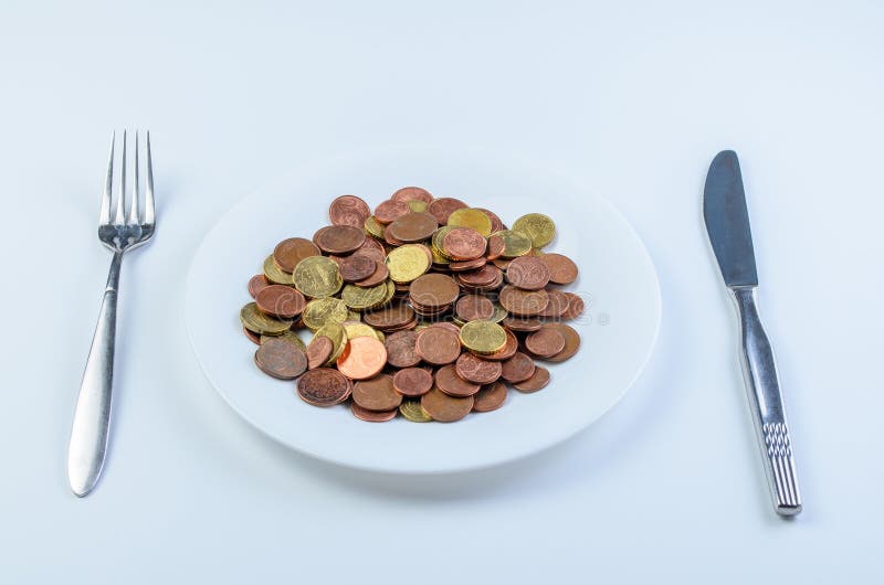 Small Copper Coins on a White Plate with Fork and Knife Stock Image ...
