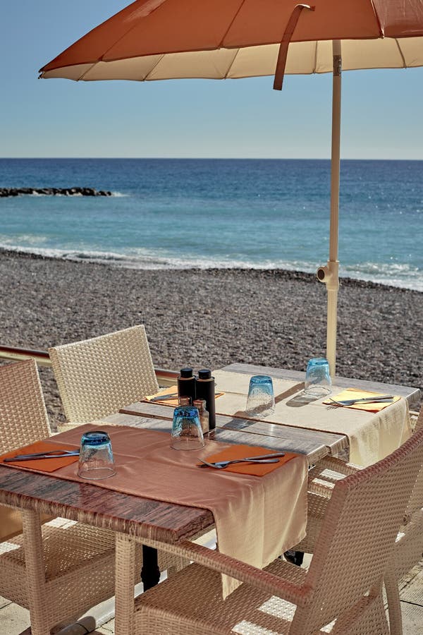 A Small Cozy Table in the Sun Next To the Calm Sea. Stock Photo - Image ...