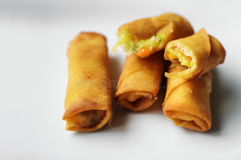 Small Crispy Fried Spring Rolls Filled with Vegetables on a White Plate ...