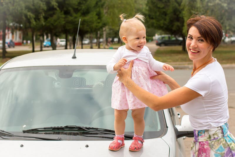 Small Cute Baby on the Car and Mom Stock Photo - Image of summer, city ...
