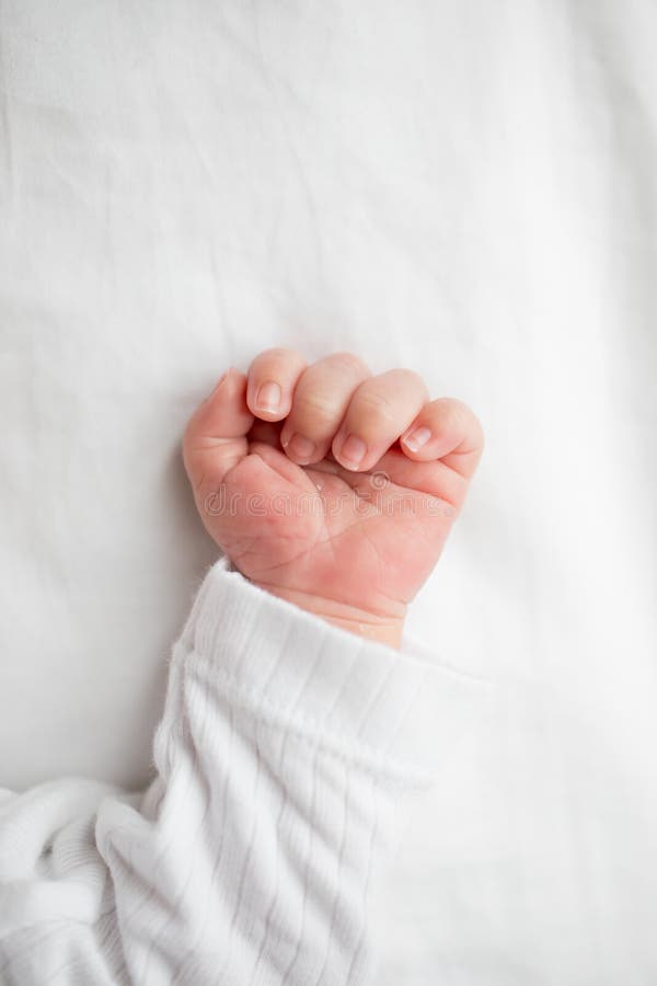 A small cute baby hand stock image. Image of grey, blanket - 183390879