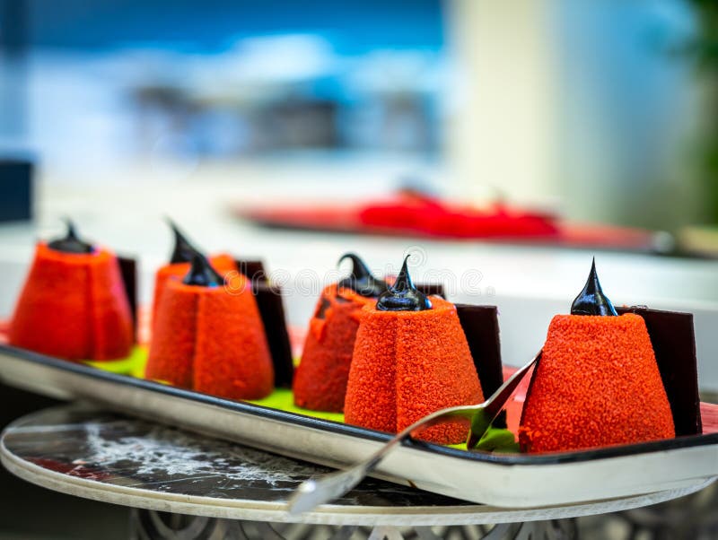 Small Cute Cakes Decorated with Chocolate Paste on a Plate in a ...