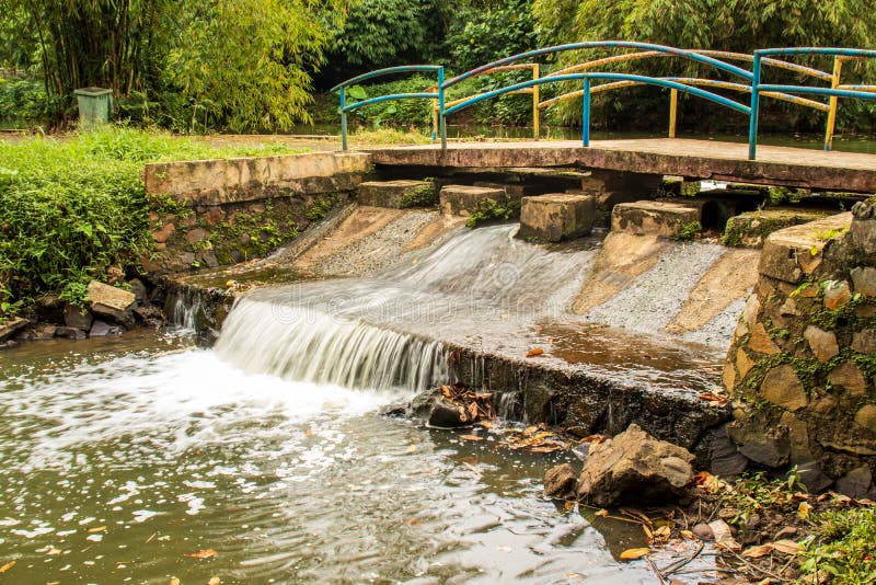 A Small Dam with a Bridge Over it with a Stream of Water Flowing ...