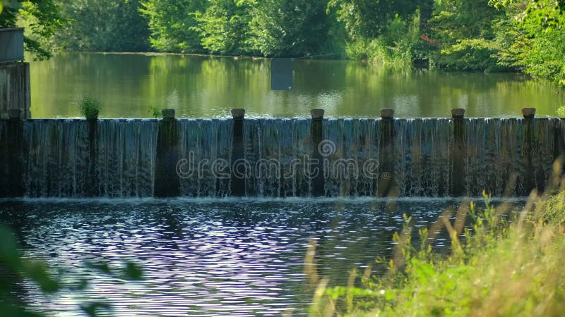A Small Dam on a River in Germany Against a Backdrop of Beautiful ...