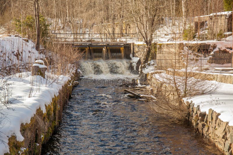 A Small Dam through Which Water Flows. Winter Landscape Stock Photo ...