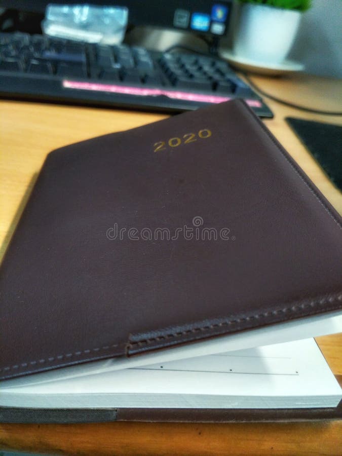A Small Dark Brown Notebook with the Words 2020 on the Front Cover ...