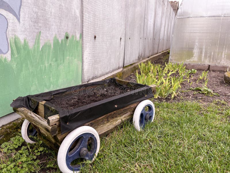 A Small Decorative Cart in the Garden in Early Spring Stock Image ...
