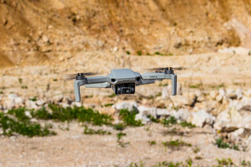 Small Drone DJI Mini 2 in Flight Against the Backdrop of a Rocky ...