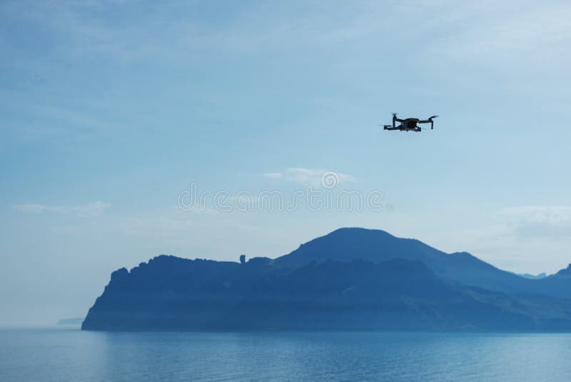 Small drone over the sea stock photo. Image of sunrise - 220934448