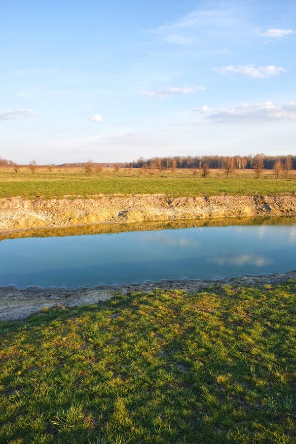 A Small Drying Pond in the Evening in the Field. Cloudy Sky Over the ...