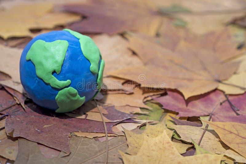 Small Earth Model on Autumn Leaves Abstract Composition of Peace Stock ...