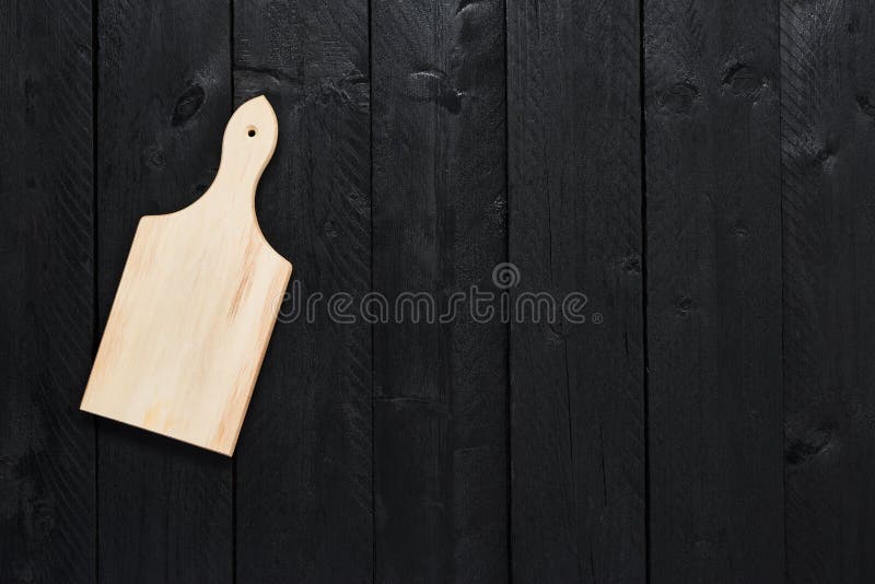 Small Empty Chopping Board on Black Wooden Table Stock Photo - Image of ...