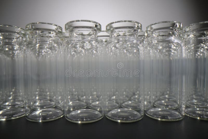Small Empty Glass Bottles on Black Table in Laboratory Stock Photo ...