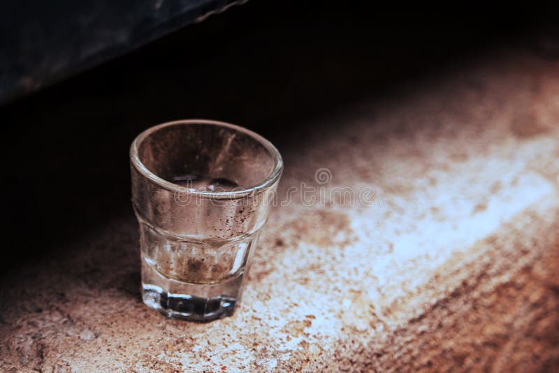 Small Empty Glass Standing Alone on Concrete Surface Stock Photo ...