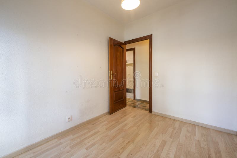 Small Empty Room with Laminated Flooring and Sapele Wood Access Door ...