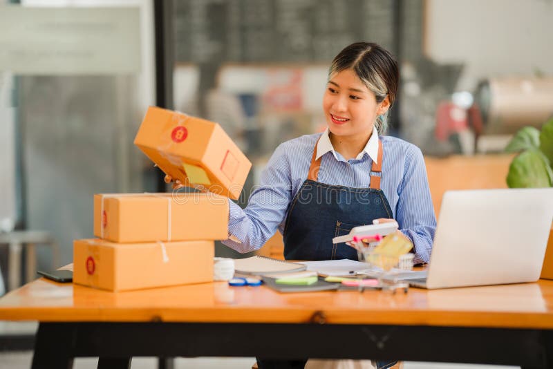 Small Entrepreneur Start Home Business by Arranging Goods with Yellow ...