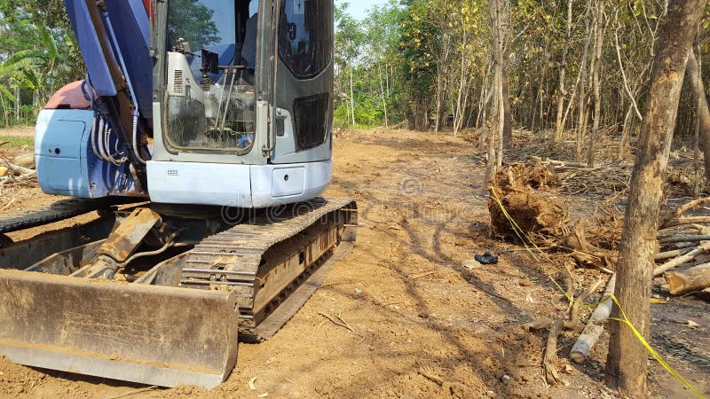 A Small Excavator is Working To Level the Ground for a Building Stock ...