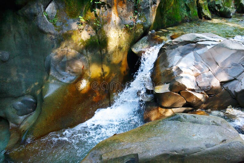 Small Fair Waterfall among the Rocks in Mountain Forest Stock Image ...