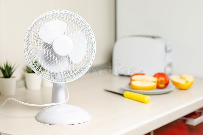 A Small Fan on the Kitchen Table. the Concept of Cooling and ...