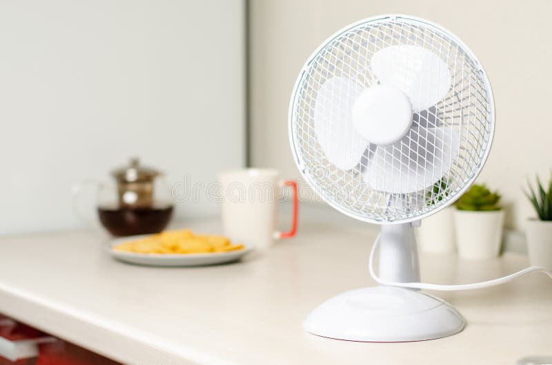 A Small Fan on the Kitchen Table. the Concept of Cooling and ...