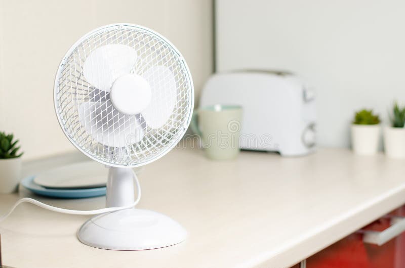 A Small Fan on the Kitchen Table. the Concept of Cooling and ...