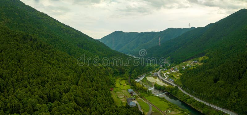 Small Farming Village in Valley between Green Forested Mountains Stock ...