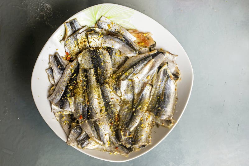 Small Fillet of Fish Marinated before Cooking in a Plate on the Table ...