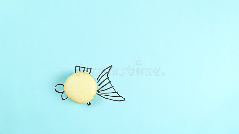 Small Fish Macaroon Cake on a Blue Background Concept with Copy Space ...