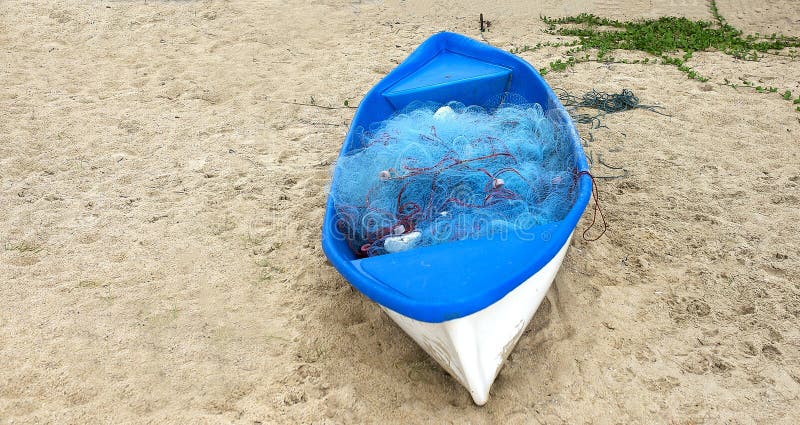 Small Fishing Boat on Shore of Beach Covered with Fishing Net Stock ...
