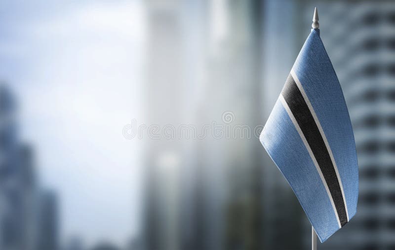 A Small Flag of Botswana on the Background of a Blurred Background ...
