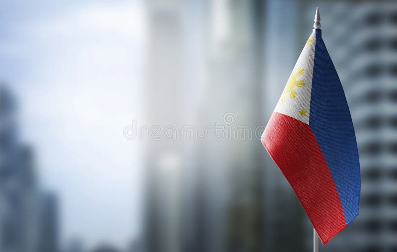 A Small Flag of Philippines on the Background of a Blurred Background ...
