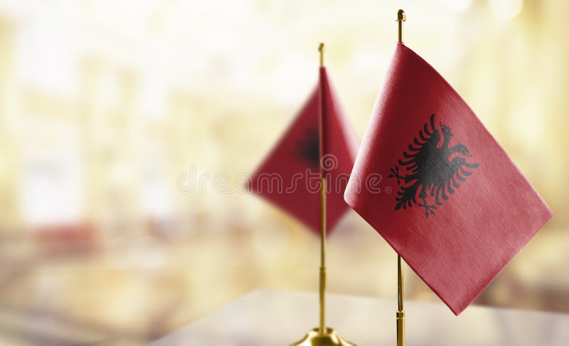 Small Flags of the Albania on an Abstract Blurry Background Stock Photo ...