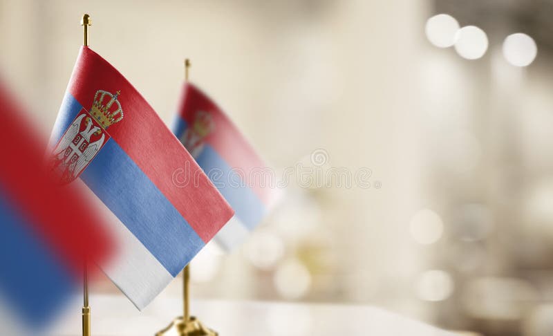 Small Flags of the Serbia on an Abstract Blurry Background Stock Photo ...