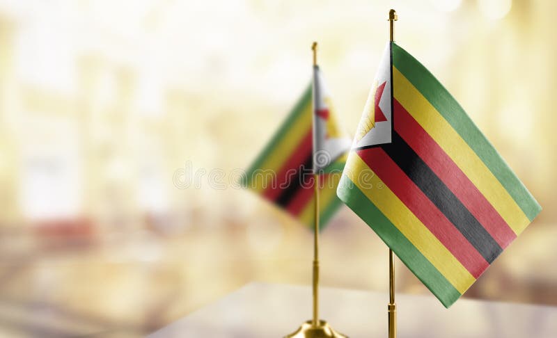 Small Flags of the Zimbabwe on an Abstract Blurry Background Stock ...