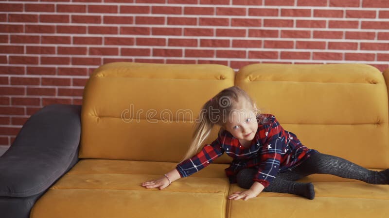 Small Girl Doing Somersault or Forward Roll on Sofa at Home Stock Video ...