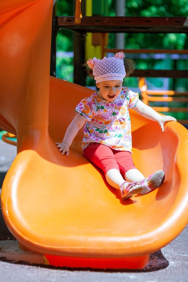 Small Girl Having Fun on a Slide Stock Image - Image of sunny, lovely ...