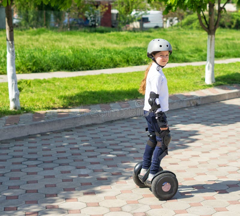 Small Girl Learns To Ride Electric Mini Hoverboard Stock Photo - Image ...